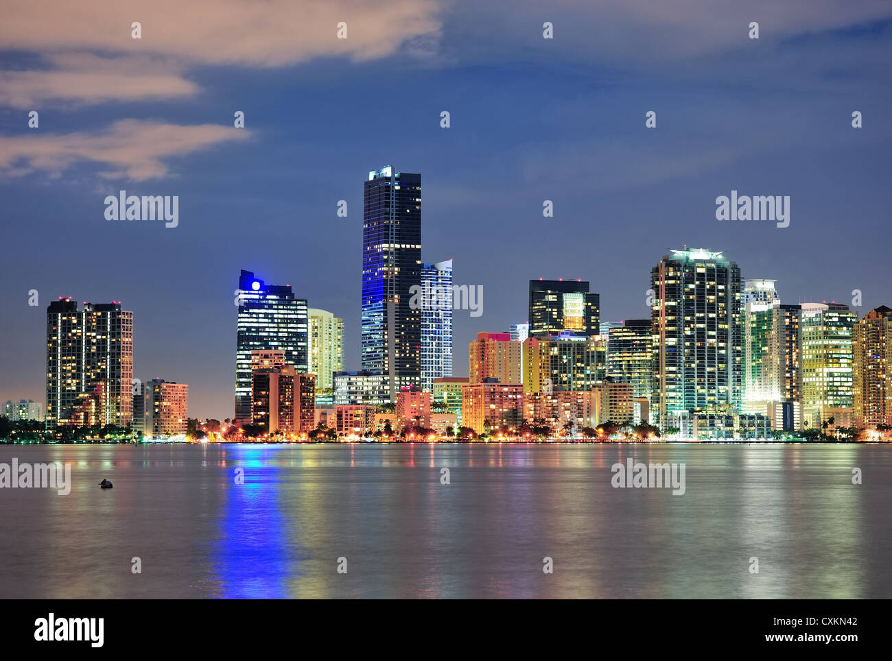 Miami city skyline panorama at dusk with urban skyscrapers over sea ...
