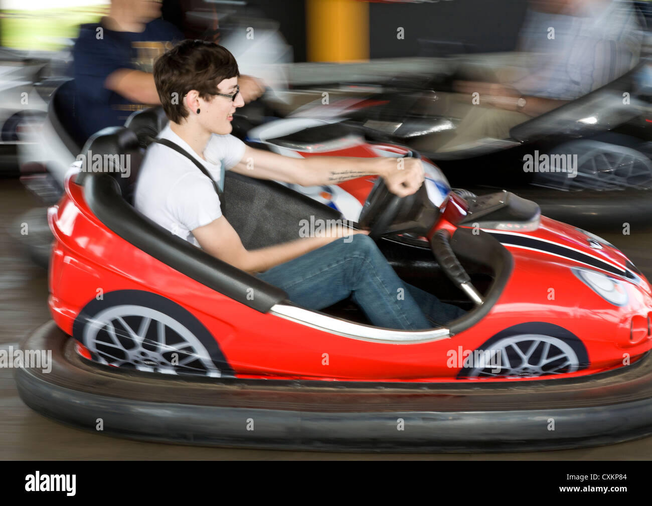 Teenager in a red bumper car Stock Photo - Alamy