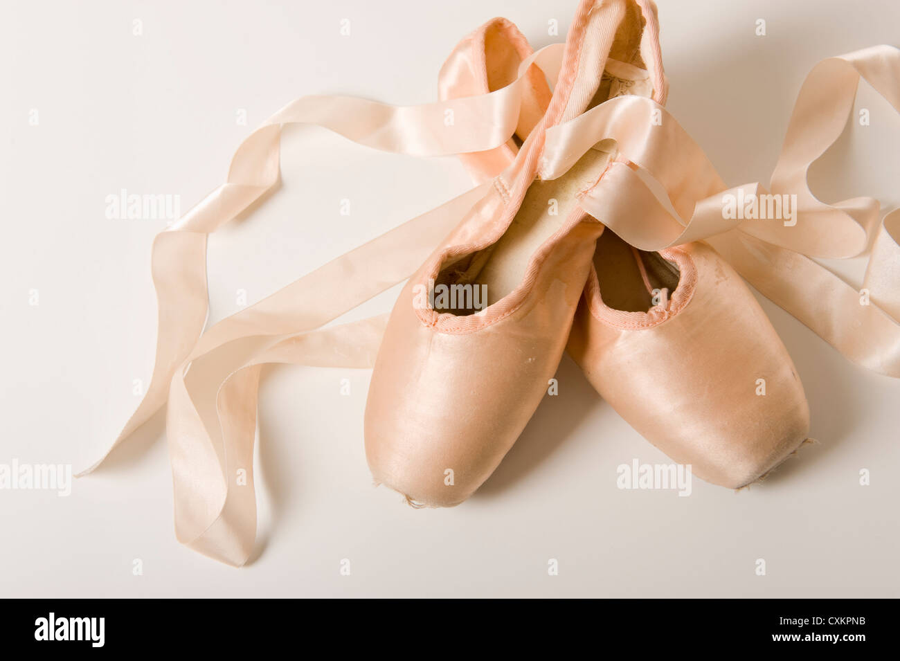 A pair of ballet shoes on a white background Stock Photo - Alamy