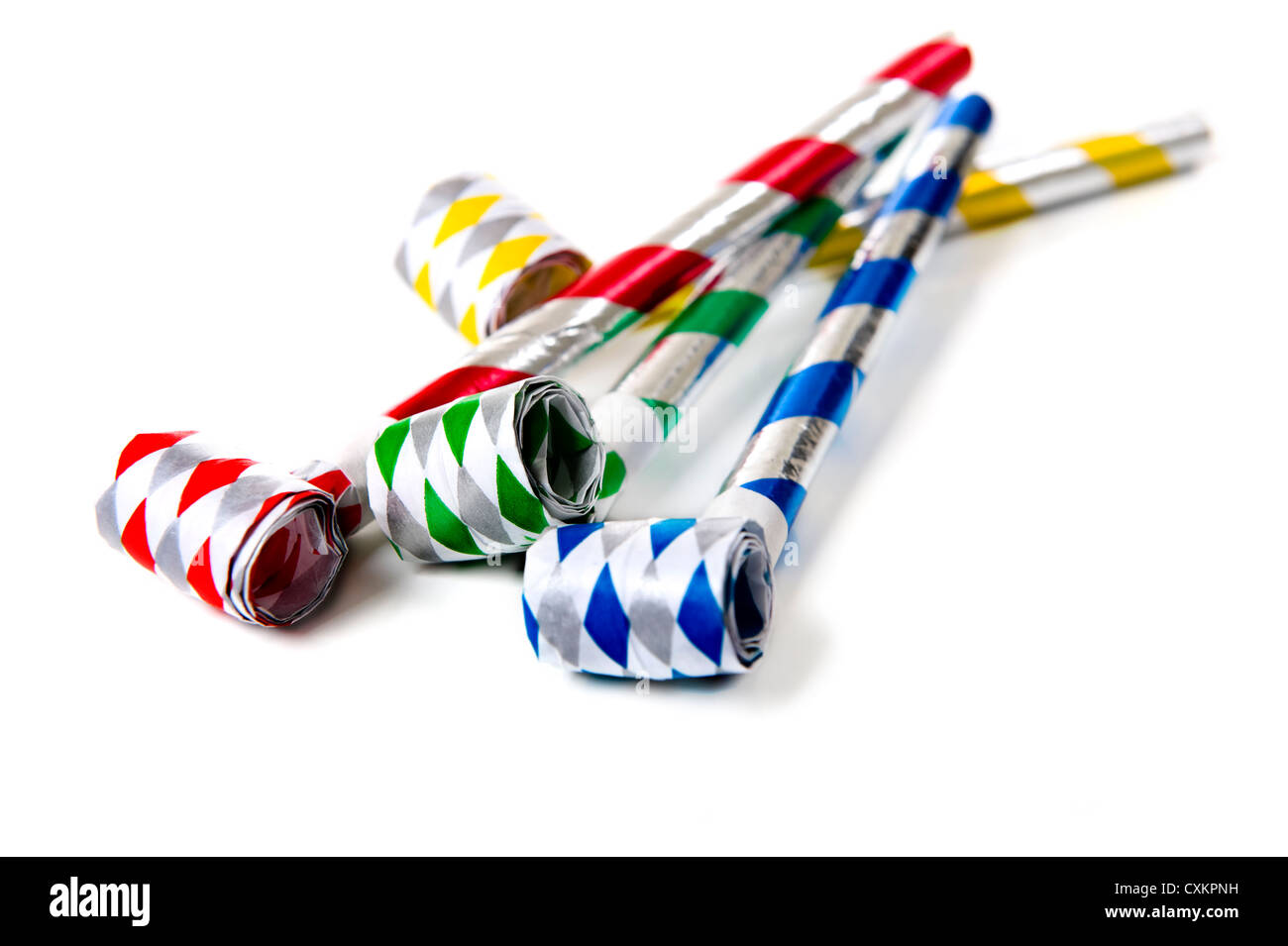 A group of colorful party noisemakers on a white background. New Years ...