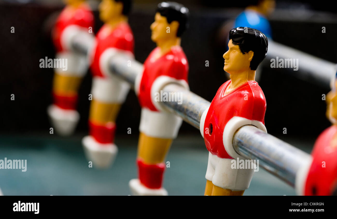 a row of foosball or table soccer playing pieces Stock Photo - Alamy