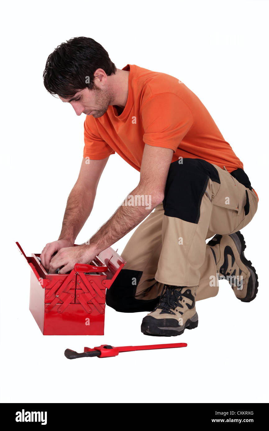 Man searching for a tool in his toolbox Stock Photo - Alamy