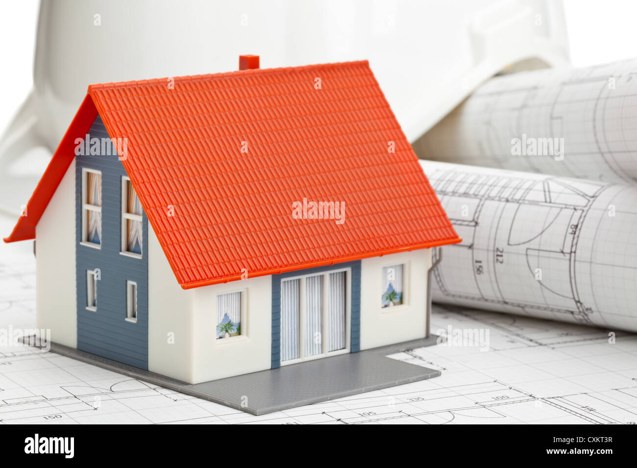 Model house on construction blueprints layed out on table Stock Photo ...