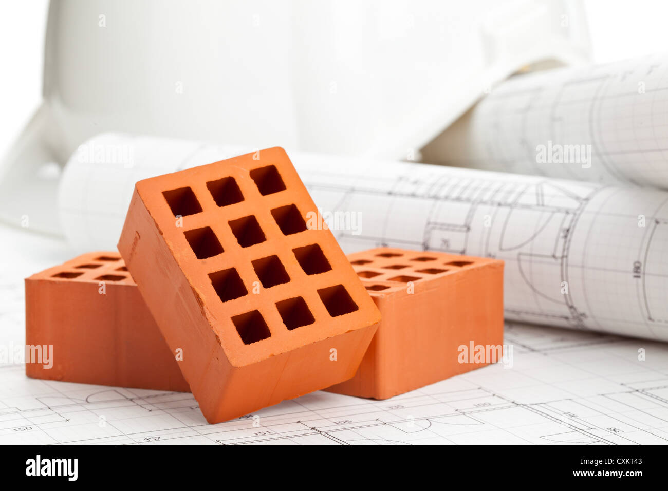 Brick stones on home construction blueprints - house building or ...