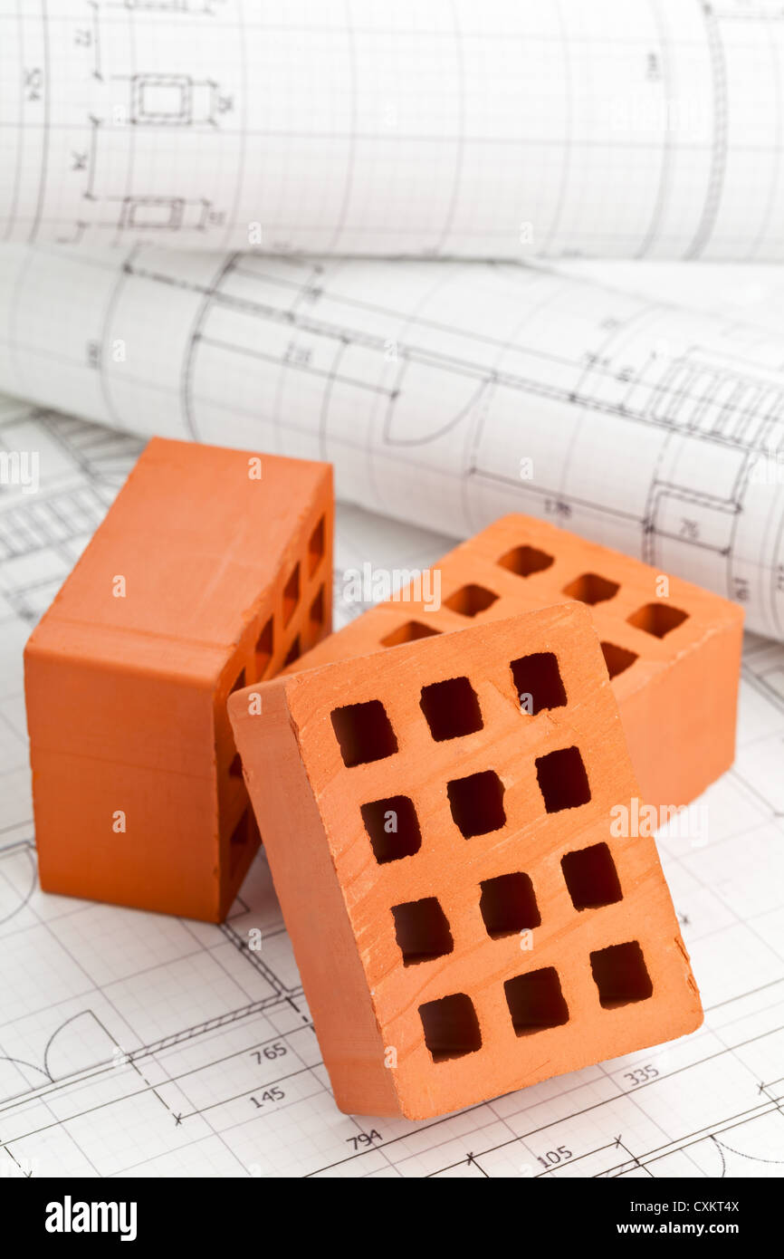 Brick stones on home construction blueprints - house building or ...