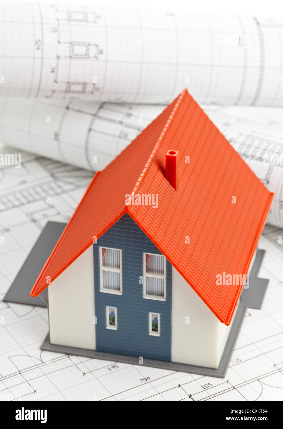 Model house on construction blueprints layed out on table Stock Photo ...