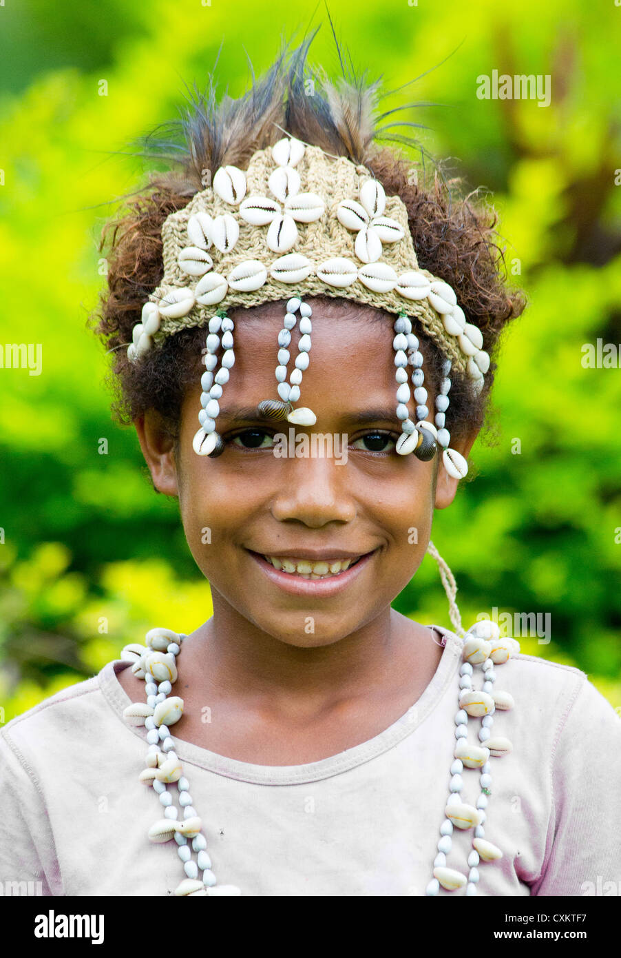 Young village girl wearing a shell headdress and necklace and smiling ...