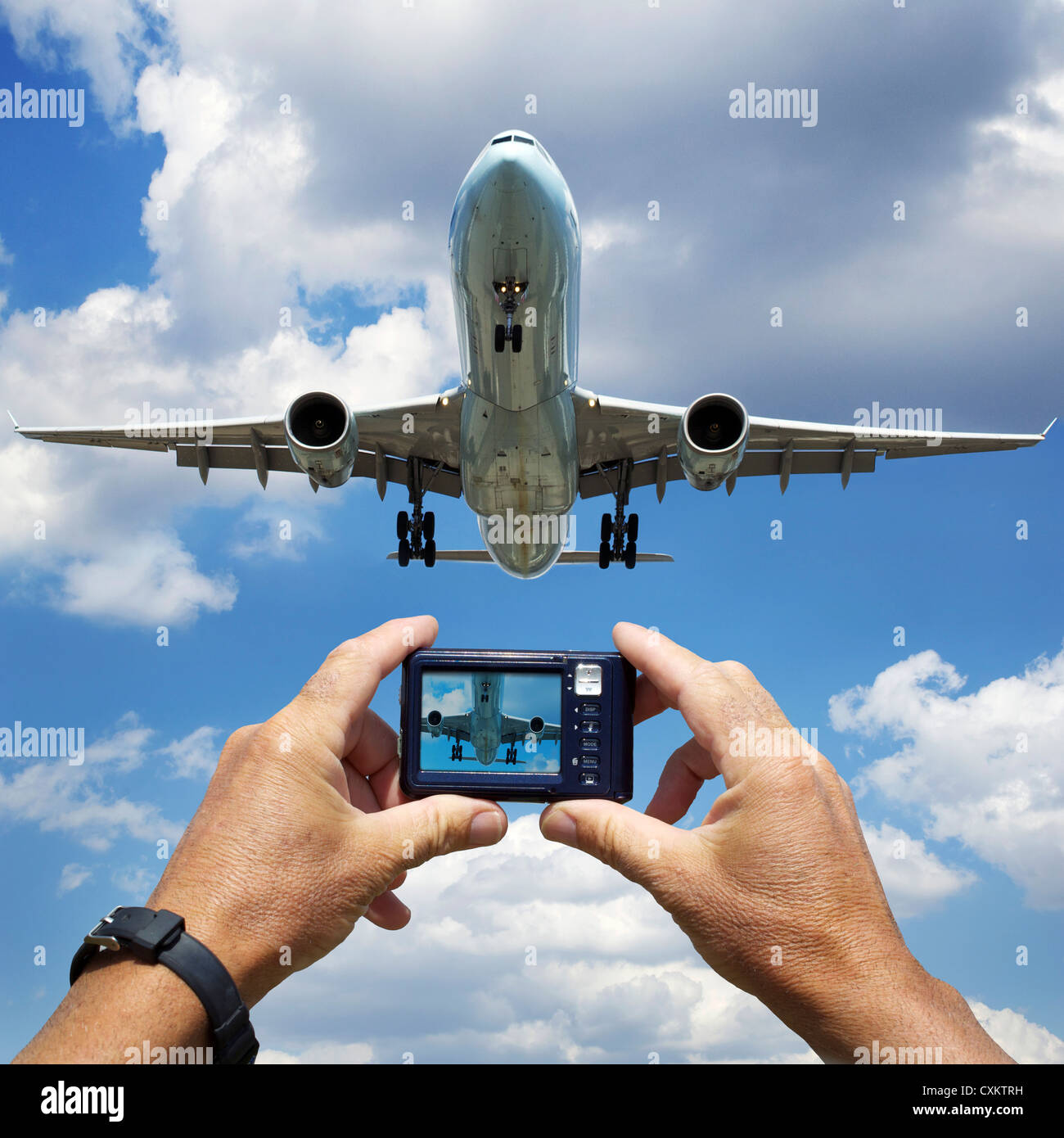 Hands holding Digital Camera Photographing Jumbo Jet Landing at Pearson ...