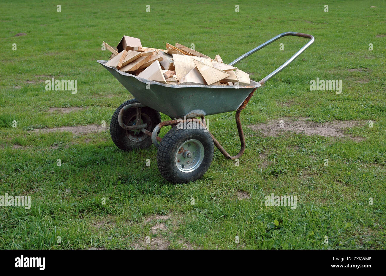 wheelbarrow with wood waste Stock Photo - Alamy