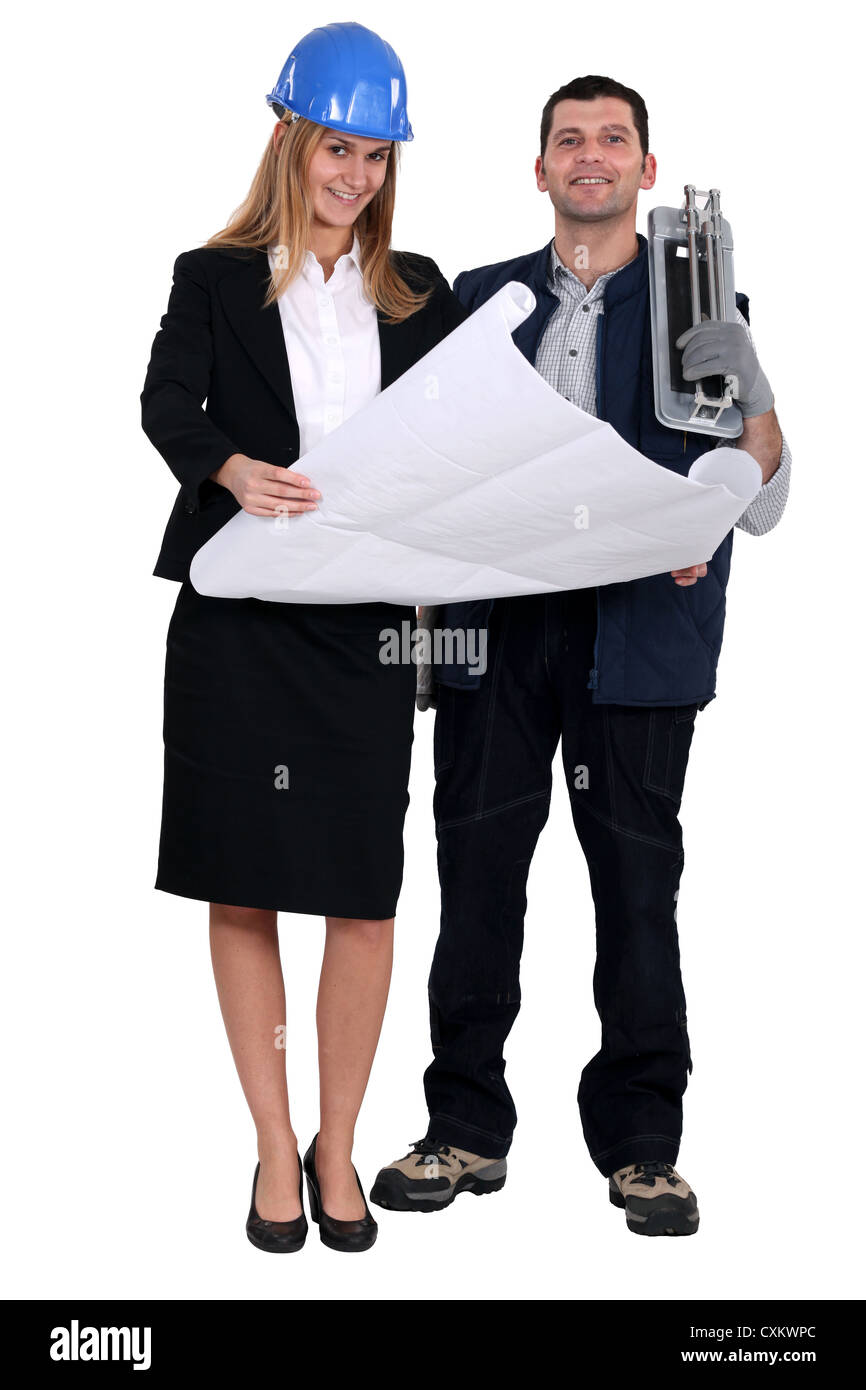 Tile cutter stood with female architect Stock Photo - Alamy