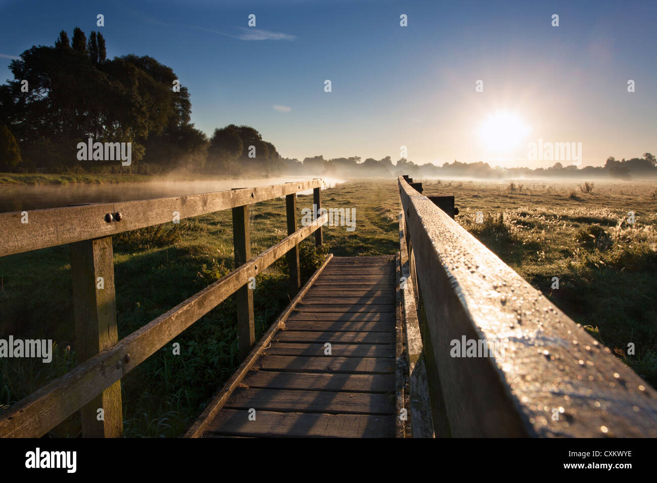 Sunrise over wooden footbridge on Ditton Meadows, Cambridge, England ...