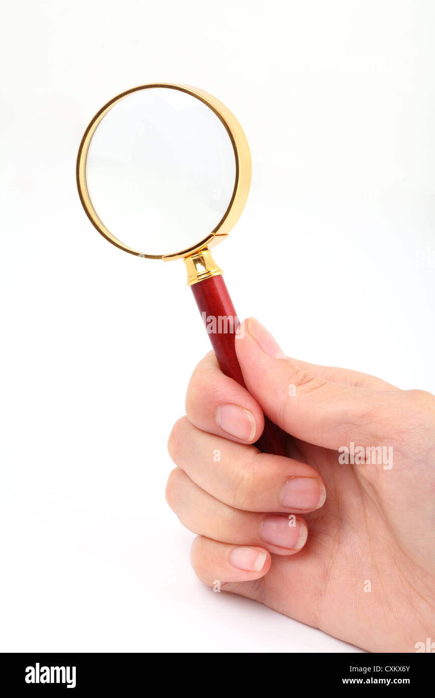 A hand holding a magnifying glass Stock Photo - Alamy