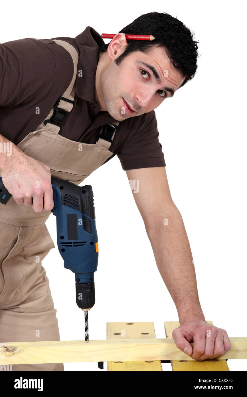 A carpenter drilling Stock Photo - Alamy