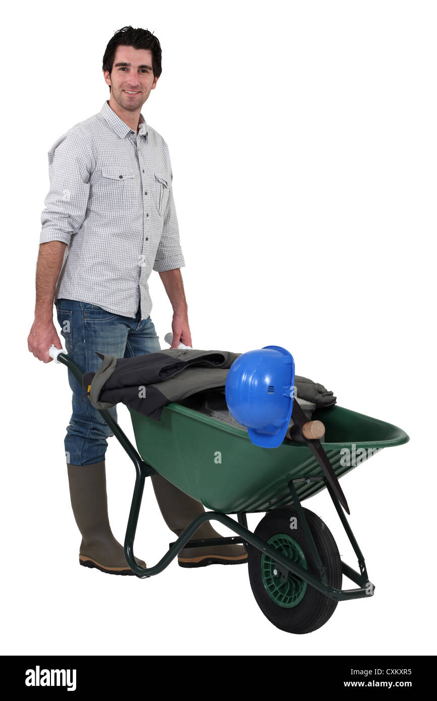 A construction worker with a wheelbarrow Stock Photo - Alamy