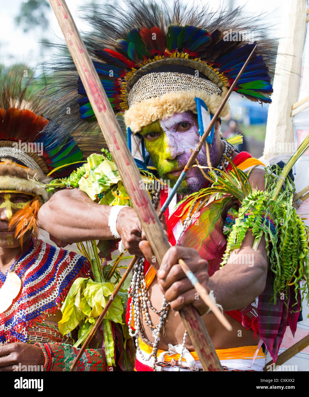 Portrait of a man with a bow and arrow and wearing traditional tribal ...
