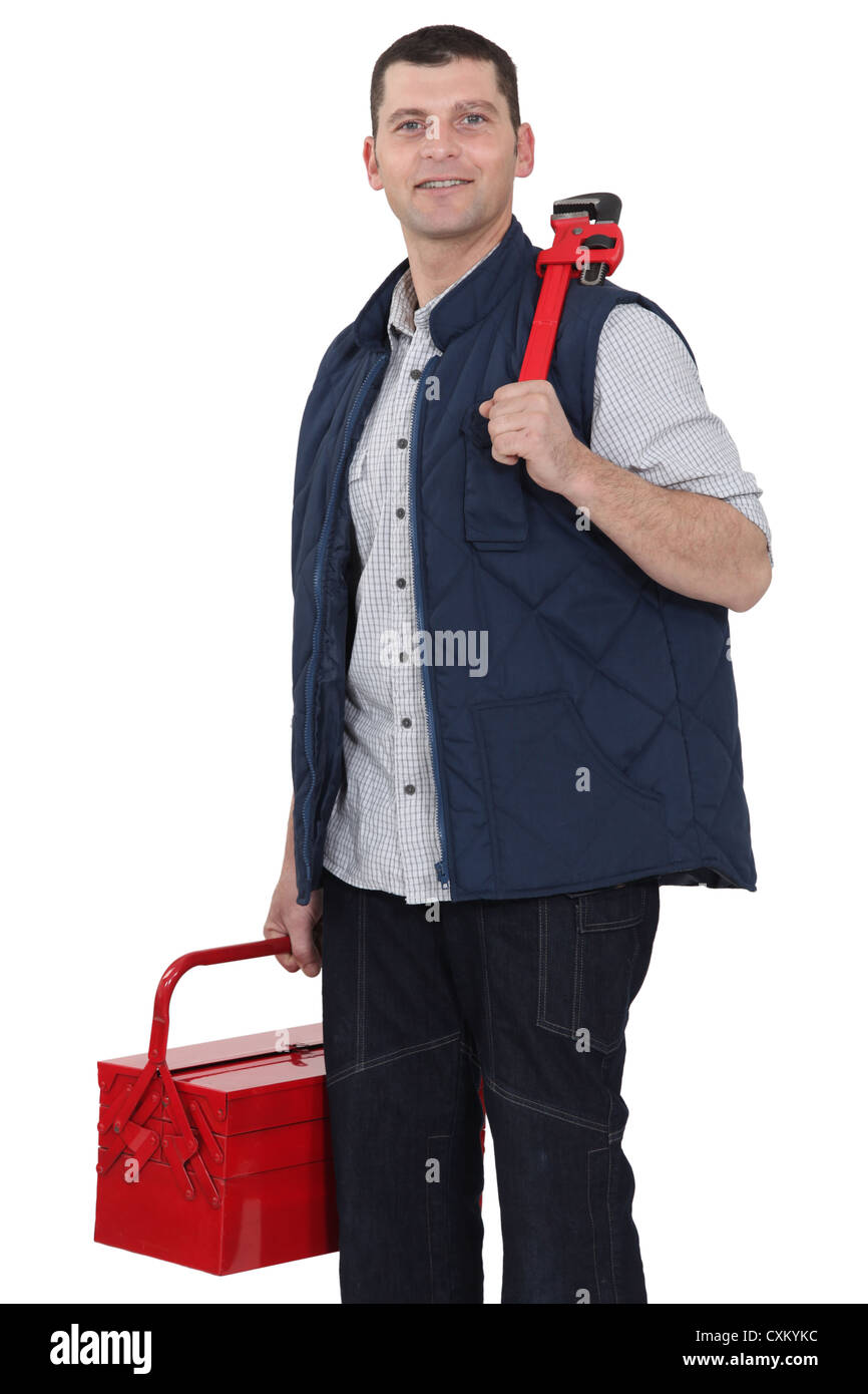 Casual worker carrying wrench and tool box Stock Photo - Alamy