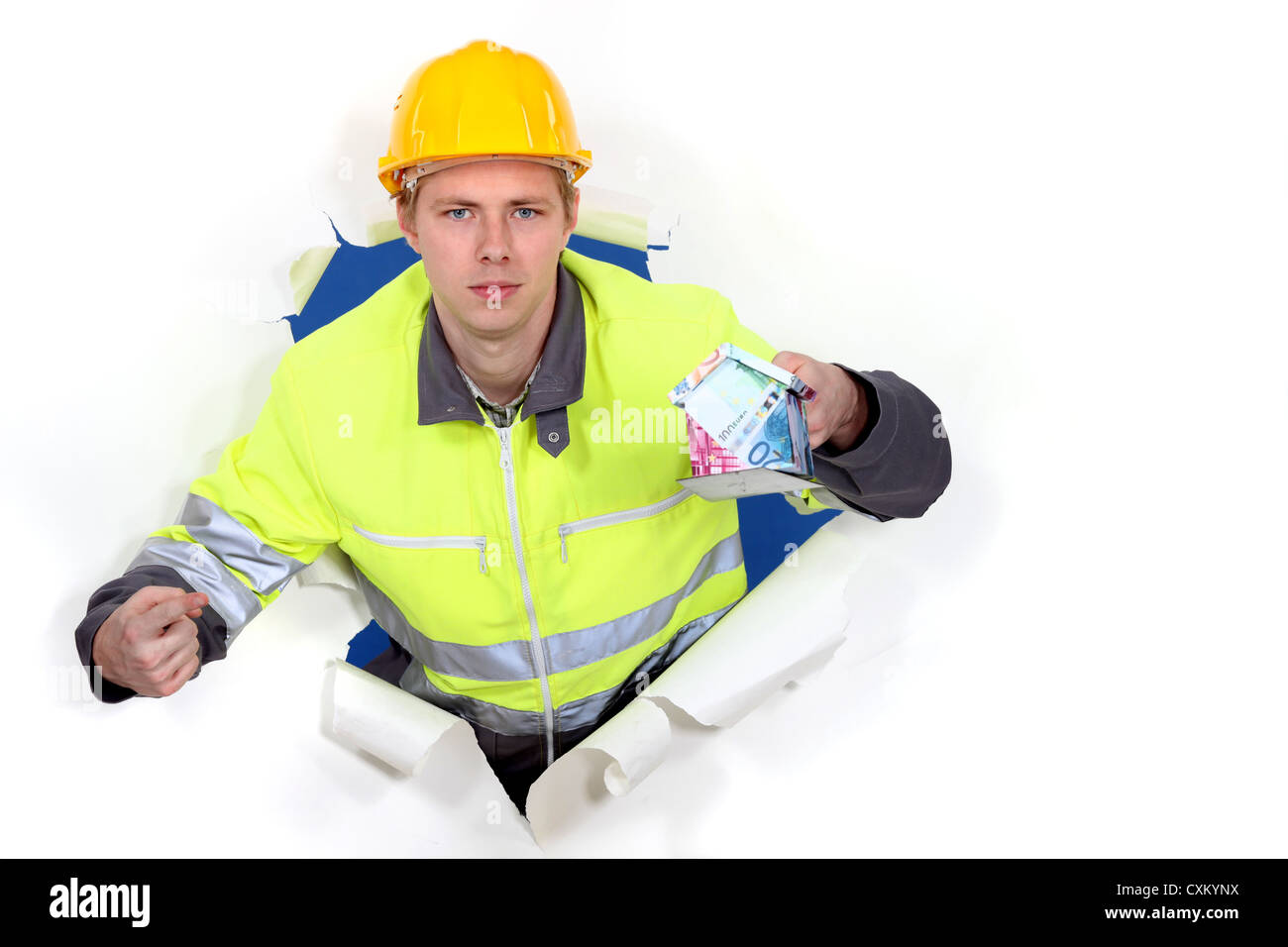 Manual worker holding cash Stock Photo - Alamy