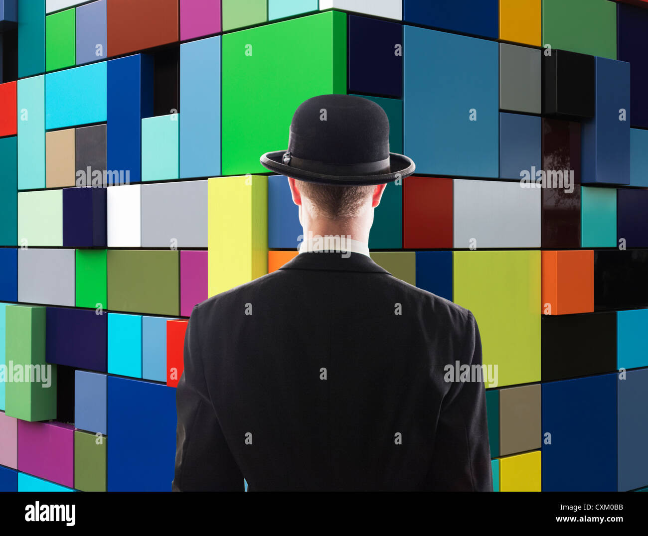 man facing multi-colored wall Stock Photo - Alamy