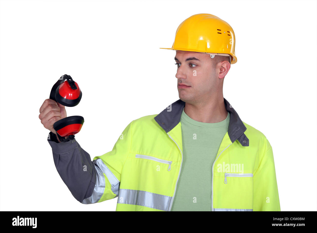 Construction worker staring at his earmuffs Stock Photo - Alamy