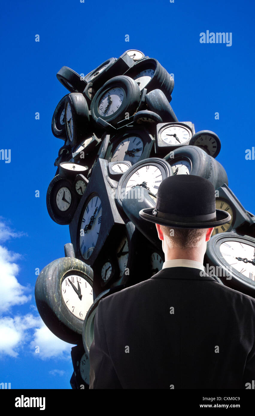 man facing a sculpture of clocks Stock Photo - Alamy