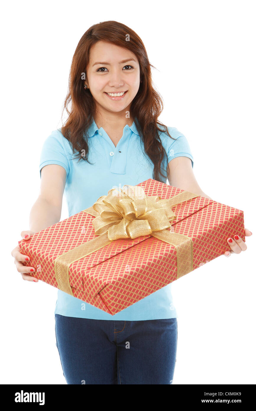 Young woman handing out a present (on white background Stock Photo - Alamy