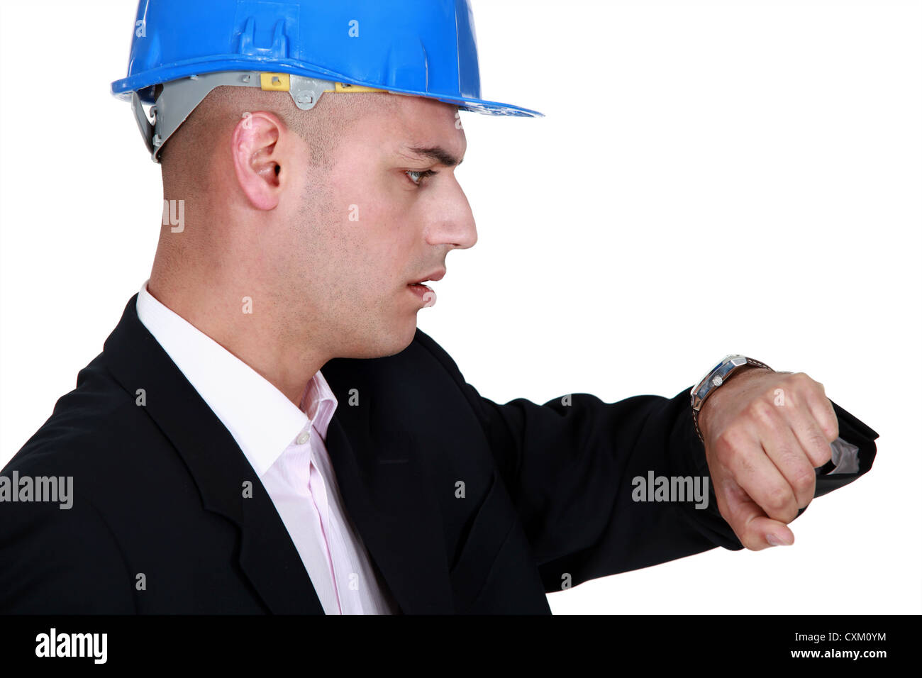 Worried engineer looking at the time Stock Photo - Alamy