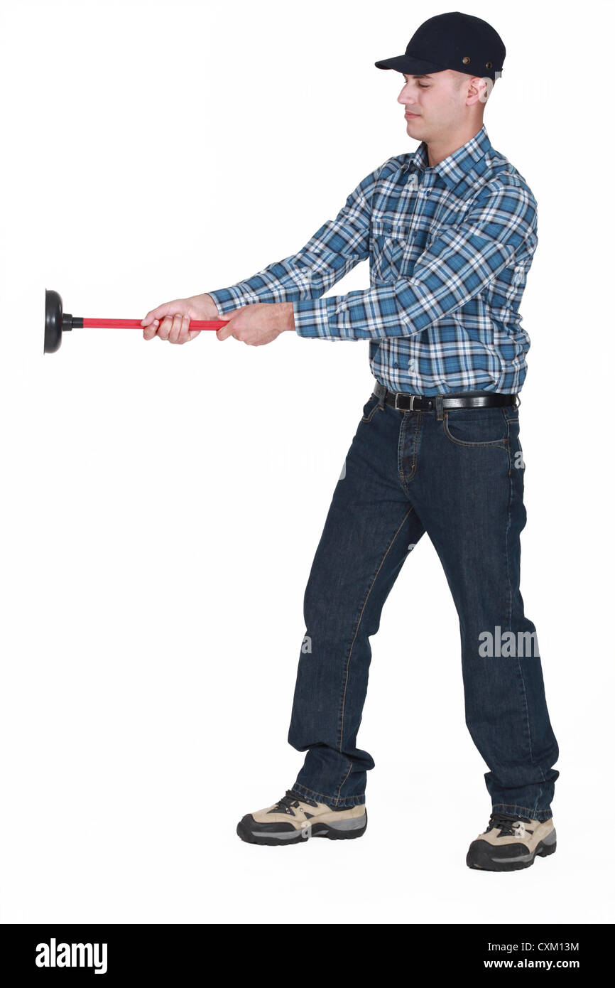 Plumber getting to grips with plunger Stock Photo - Alamy