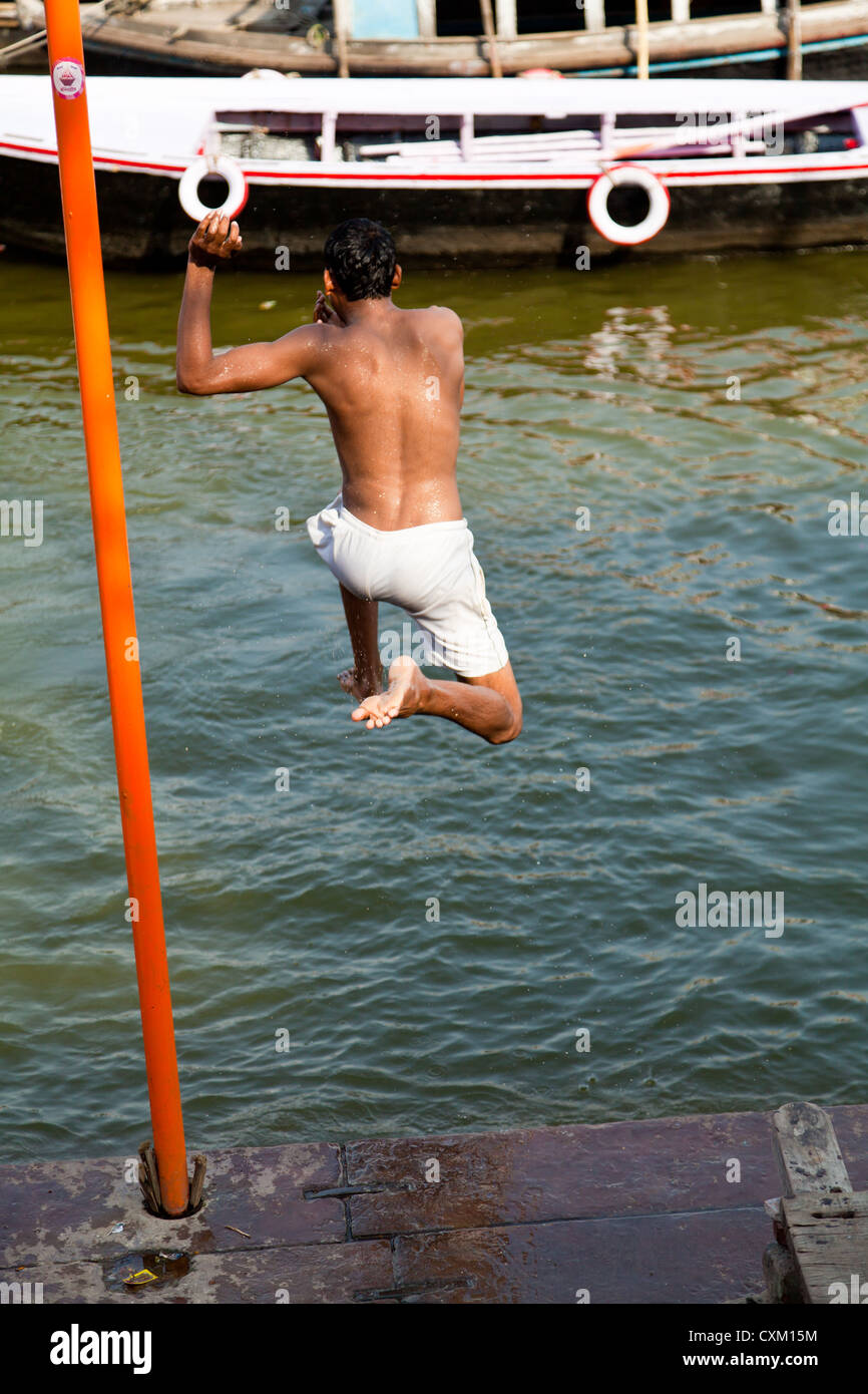 Man jumping into the River Ganges in Varanasi Stock Photo - Alamy