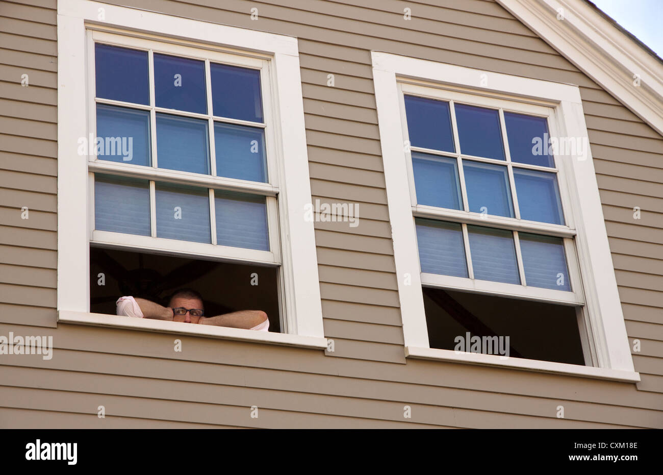 Male at window looking worried, afraid, paranoid Stock Photo - Alamy