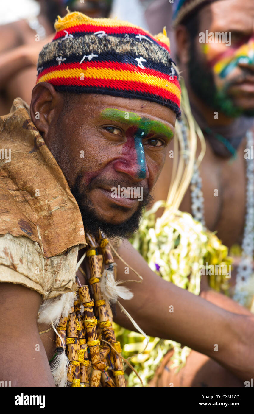 Portrait of a man with his face painted and wearing traditional costume ...