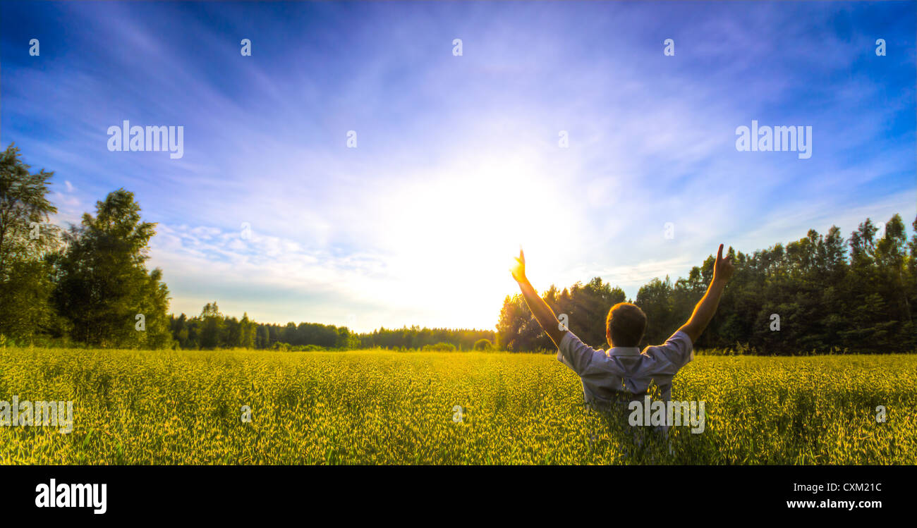 Man praising his heart out in beautiful field Stock Photo - Alamy