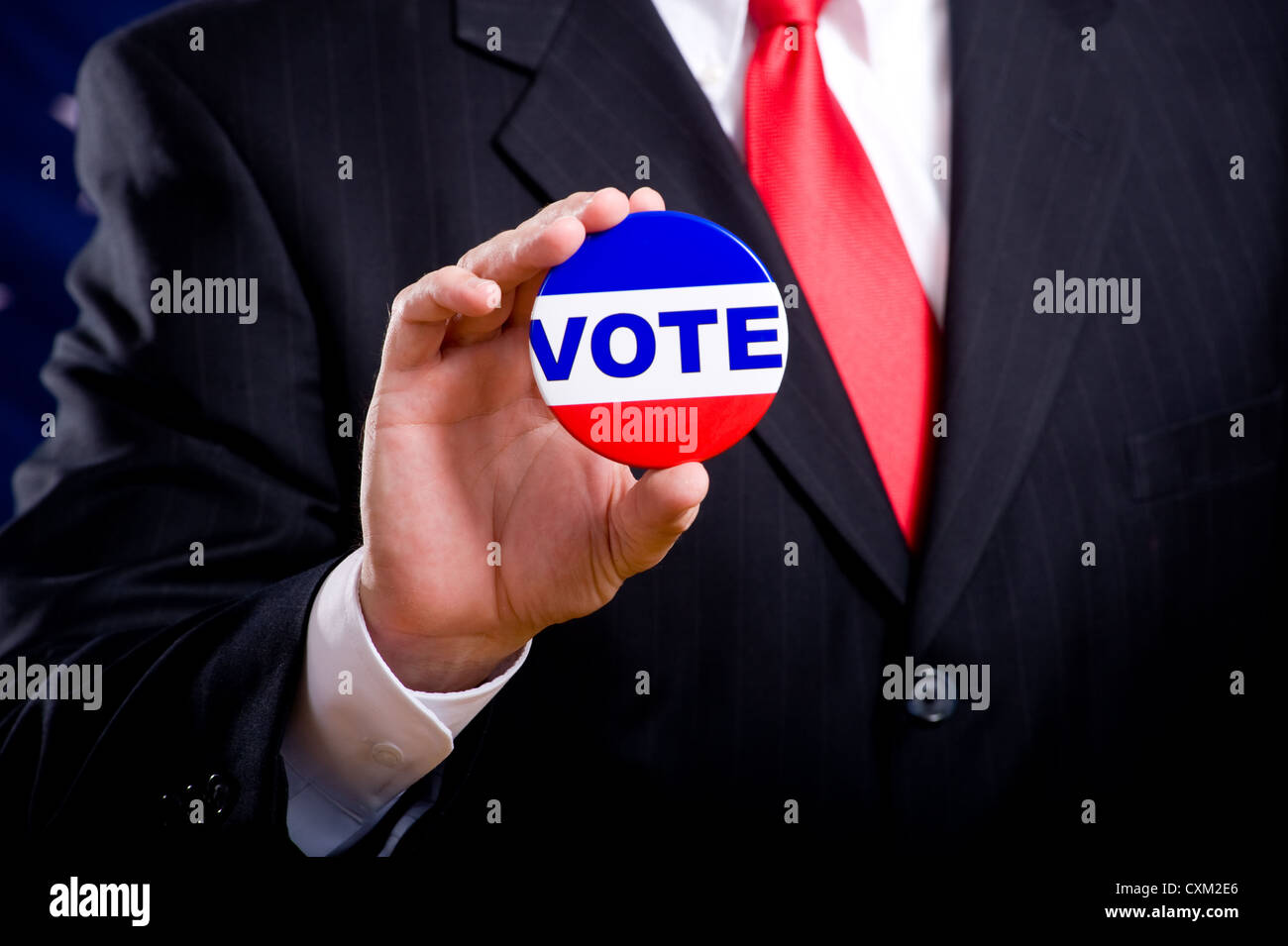 A man wearing a blue business suit and tie with a vote button. Election ...
