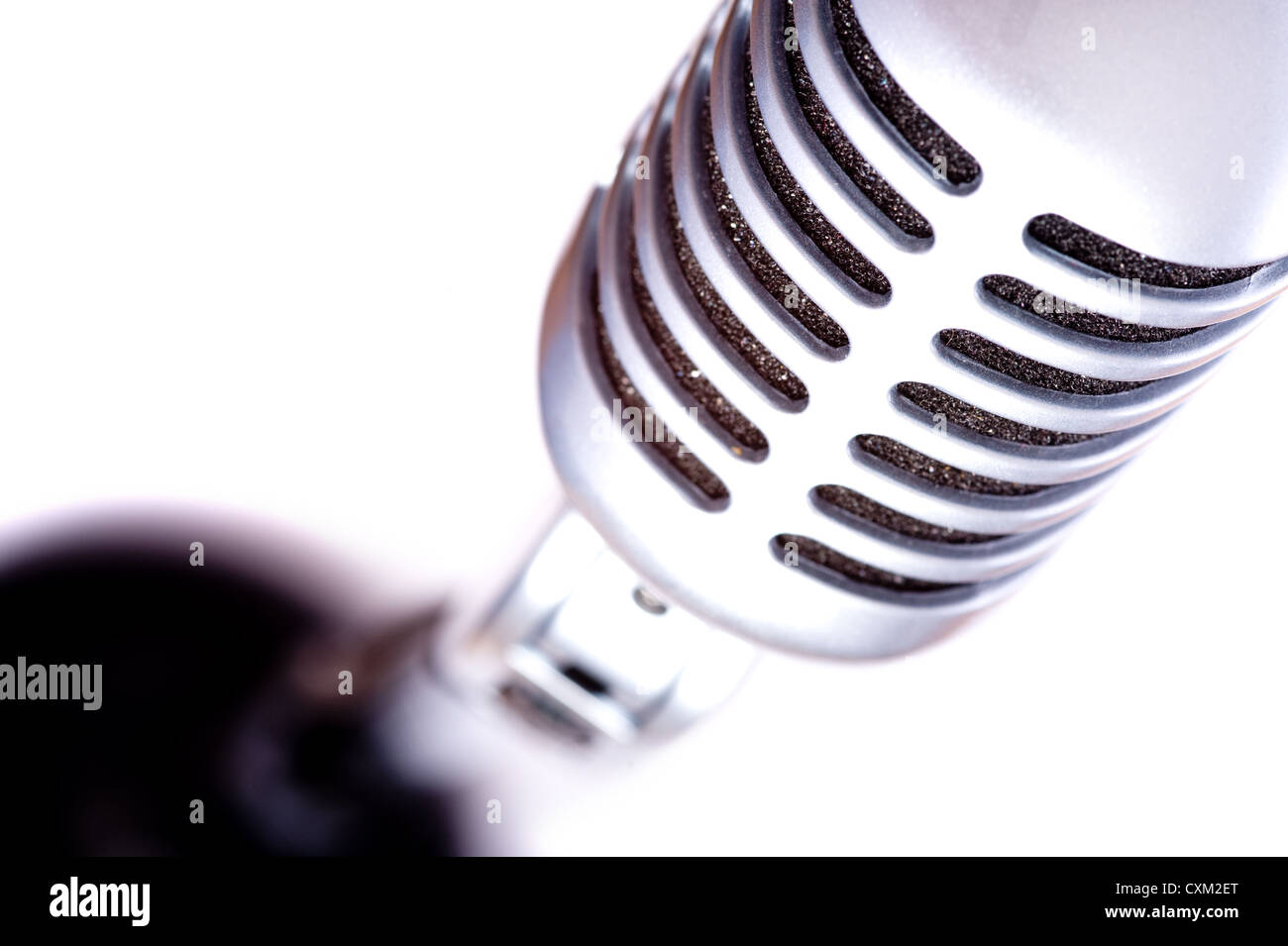 A vintage looking microphone on a white background with copy space ...