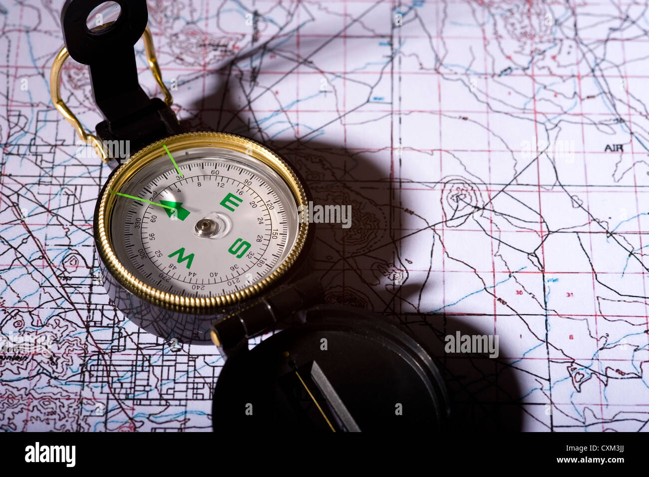 A compass lying on top of a topographical map Stock Photo - Alamy