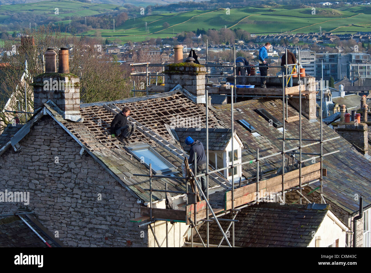 Builders working on house roof. Beast Banks, Kendal, Cumbria, England ...