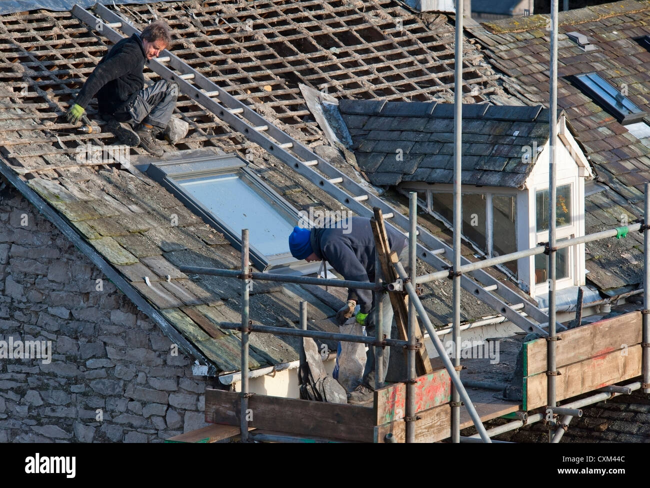Builders working on house roof. Beast Banks, Kendal, Cumbria, England ...