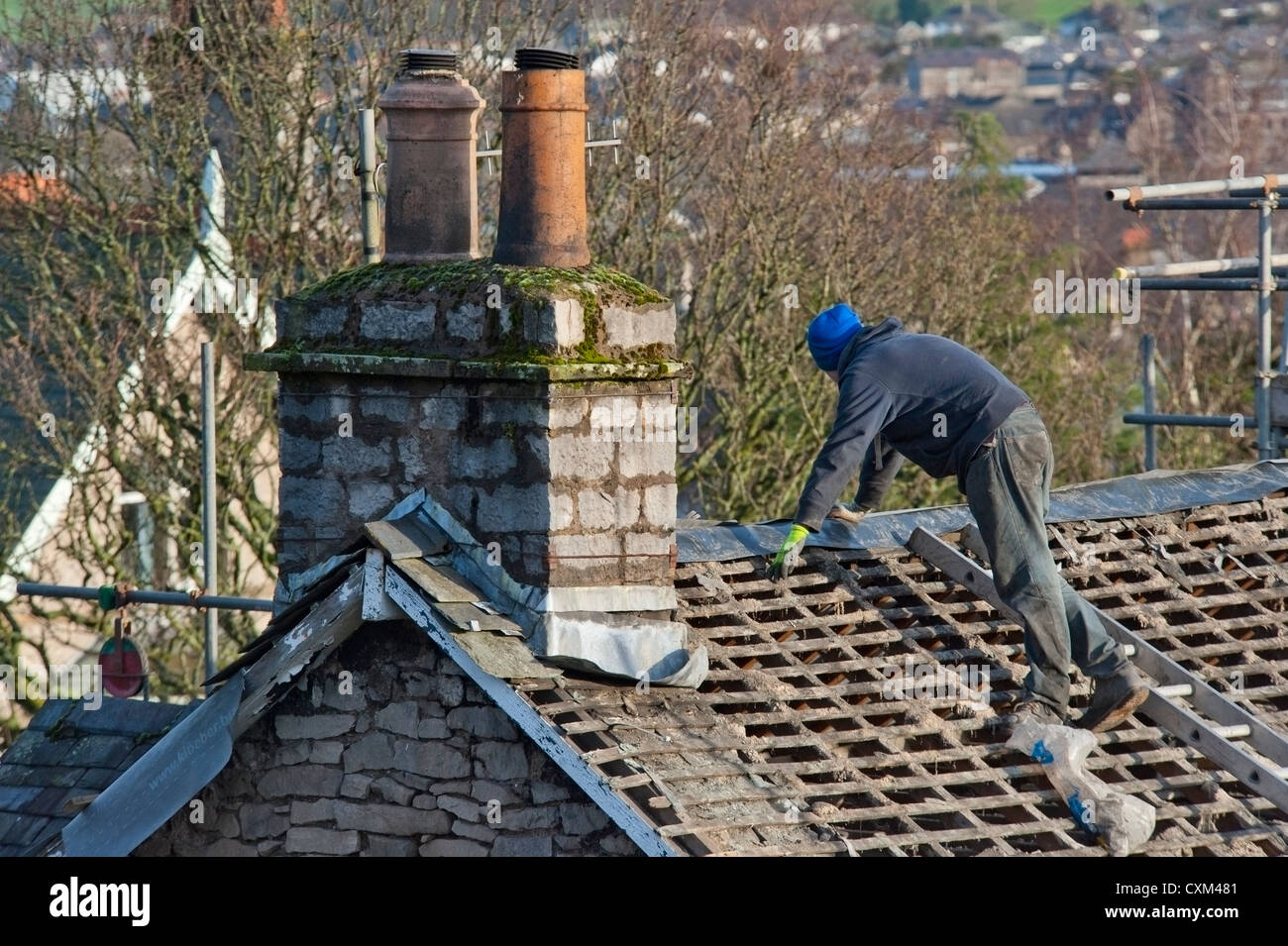 Builder working on house roof. Beast Banks, Kendal, Cumbria, England ...