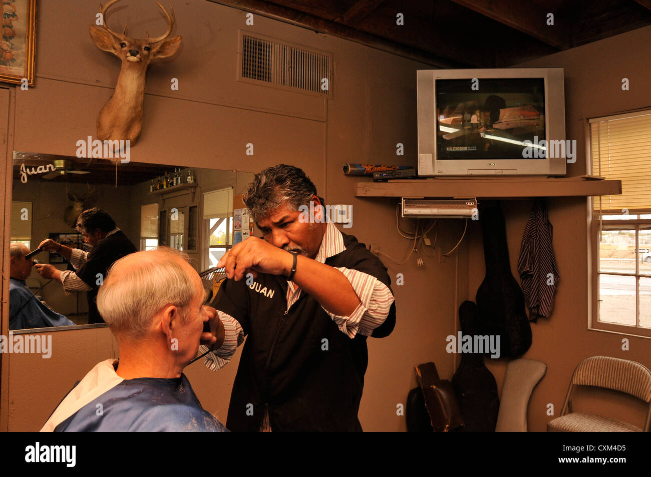 A man receives a haircut in Tucson, Arizona, USA Stock Photo - Alamy