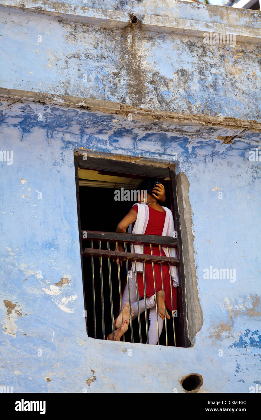 Woman leaning against a Railing in Varanasi Stock Photo - Alamy