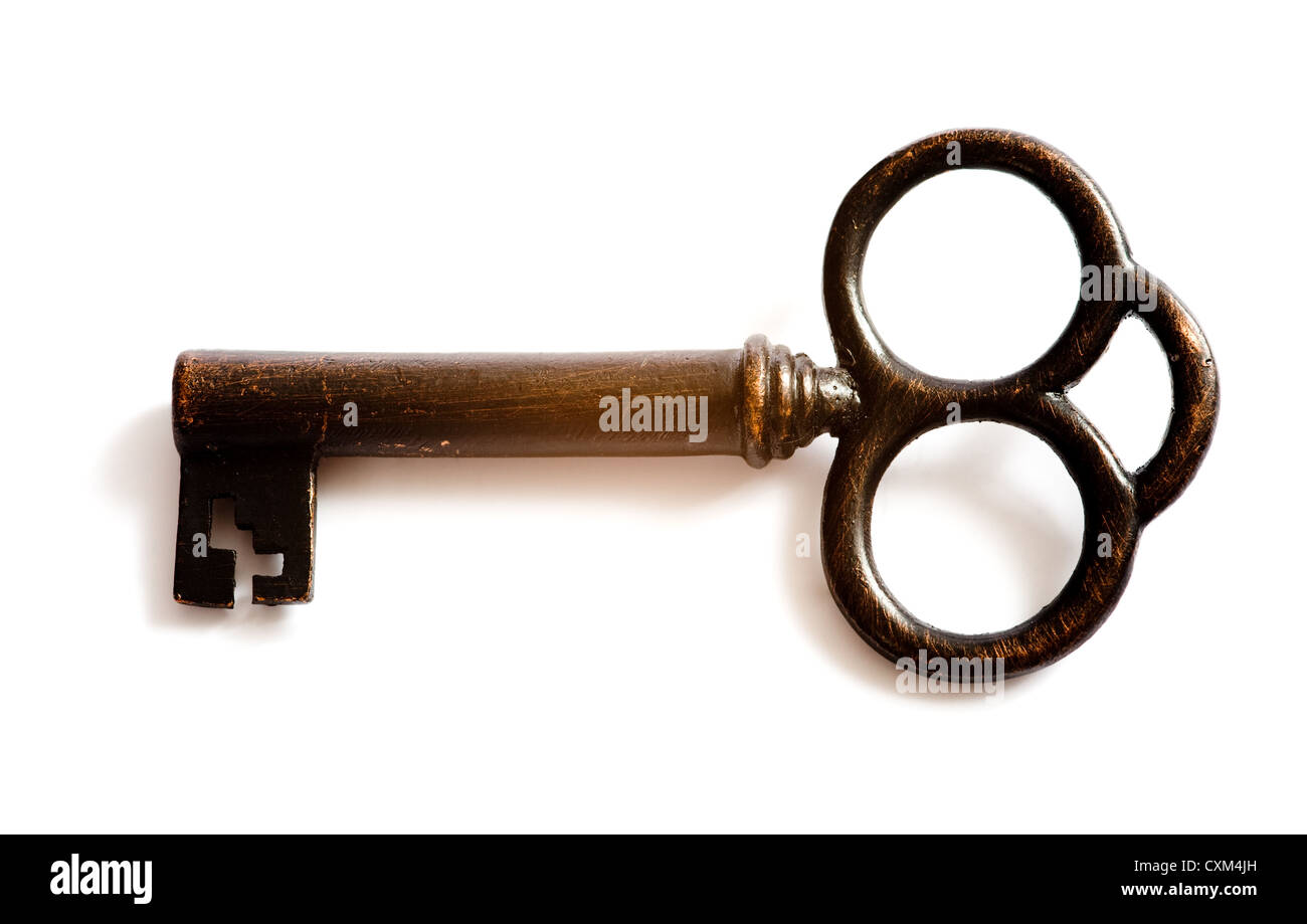 A brass, antique skeleton key on a white background Stock Photo - Alamy