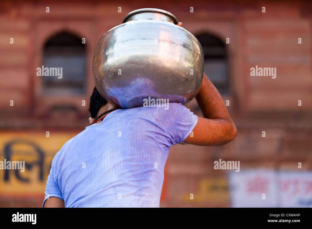 Man carrying Metal Container in Varanasi Stock Photo - Alamy