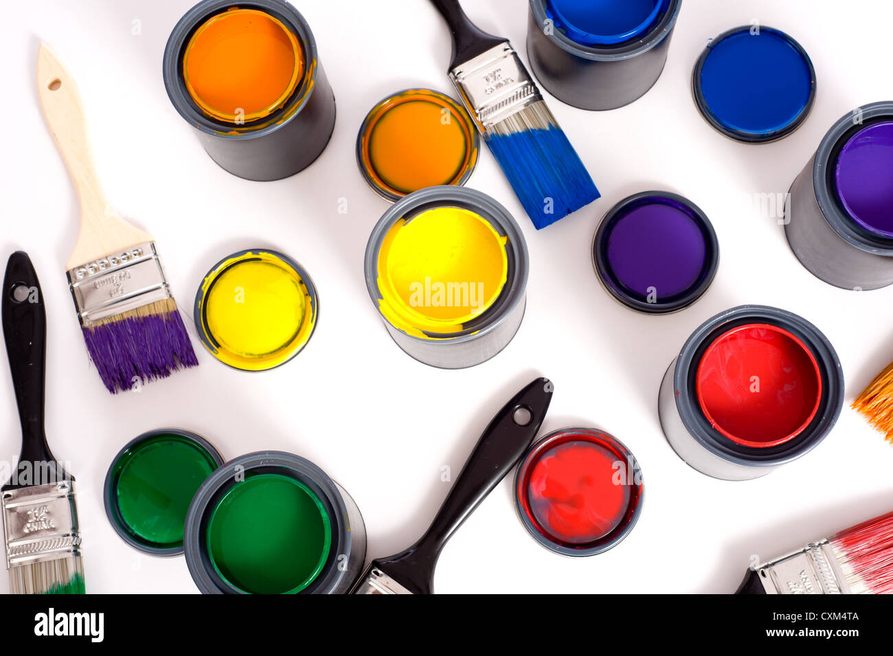 Colorful cans of paint on a white background forming a colorful ...