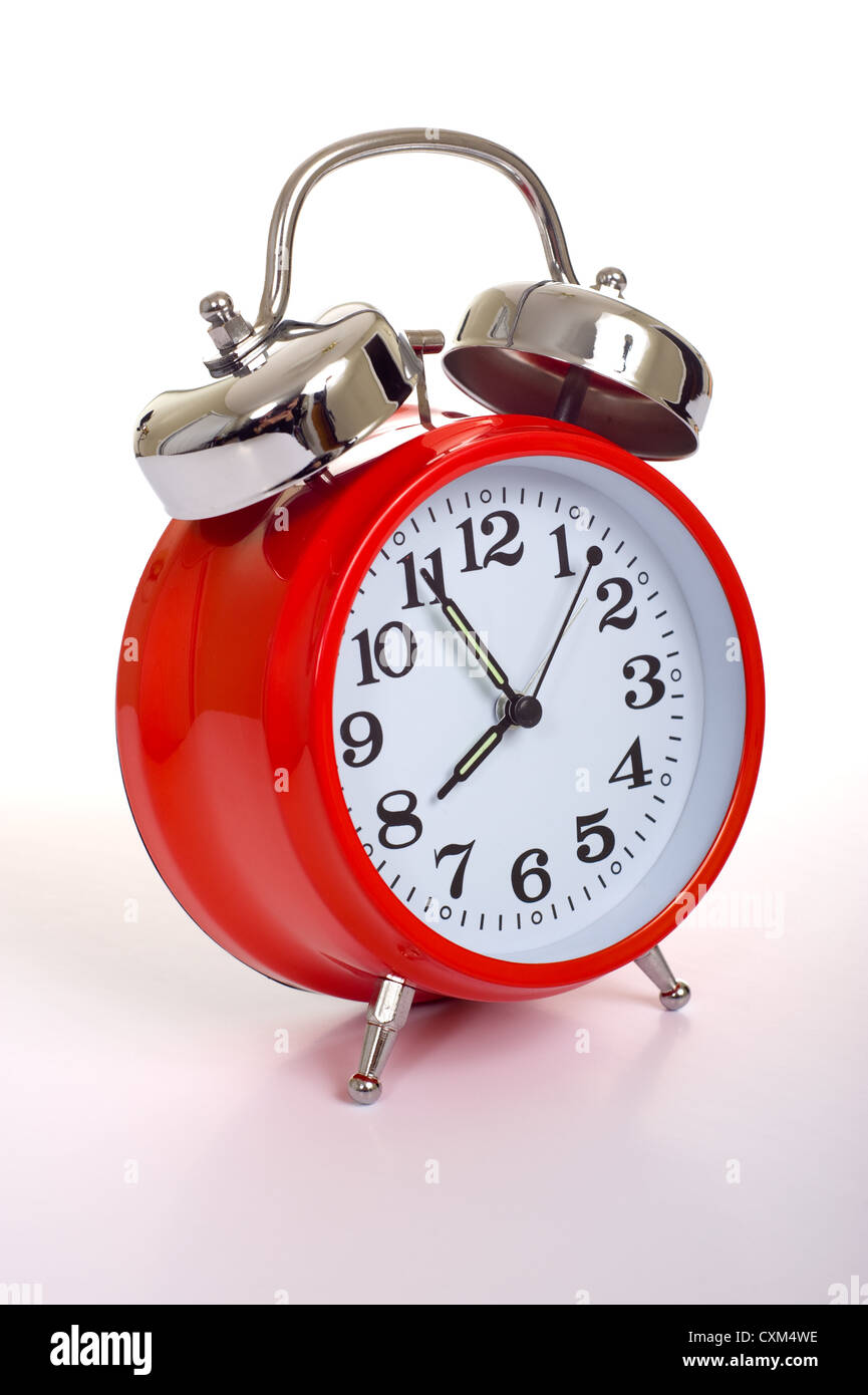 Red old fashioned alarm clock on a white background Stock Photo - Alamy
