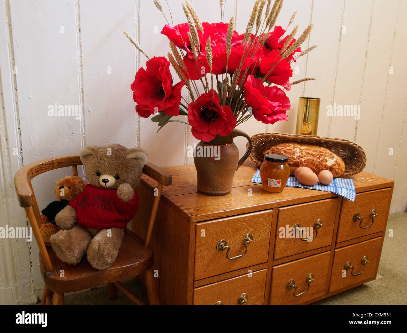 a harvest scene with bread,jam,basket,eggs,poppies and 2 old teddies ...
