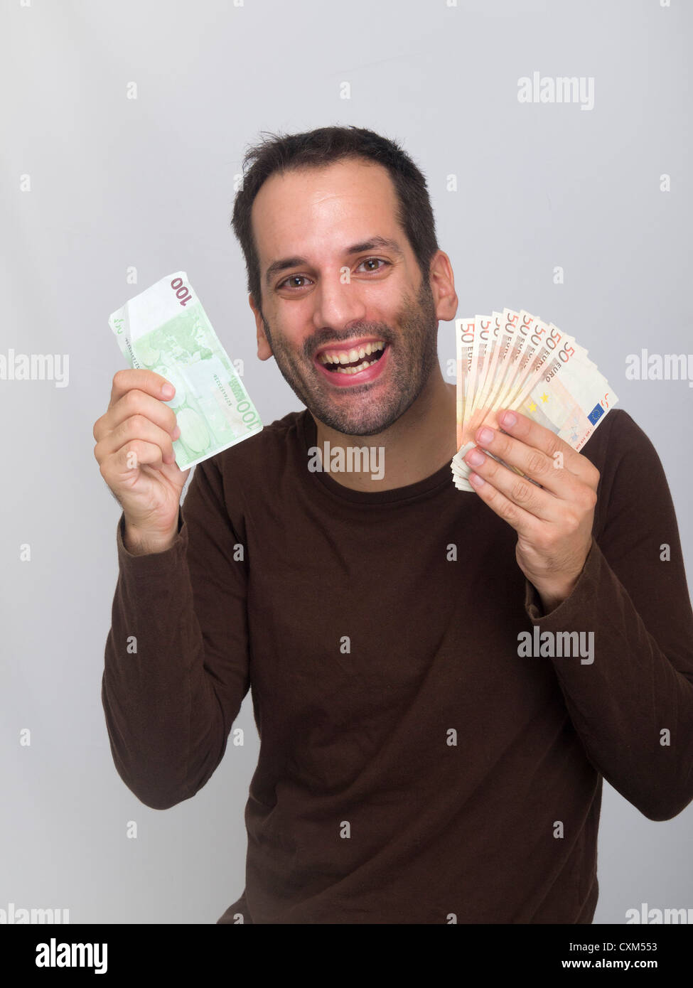 Happy young man holding money (euro bills Stock Photo - Alamy