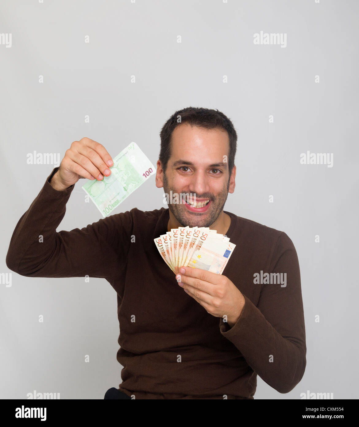 Happy young man holding money (euro bills Stock Photo - Alamy