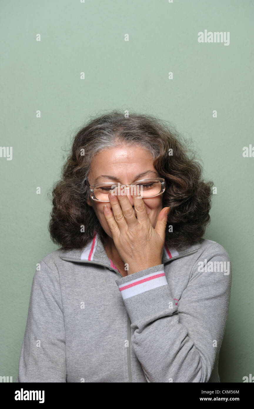 Portrait of shy woman with hands covering face Stock Photo - Alamy