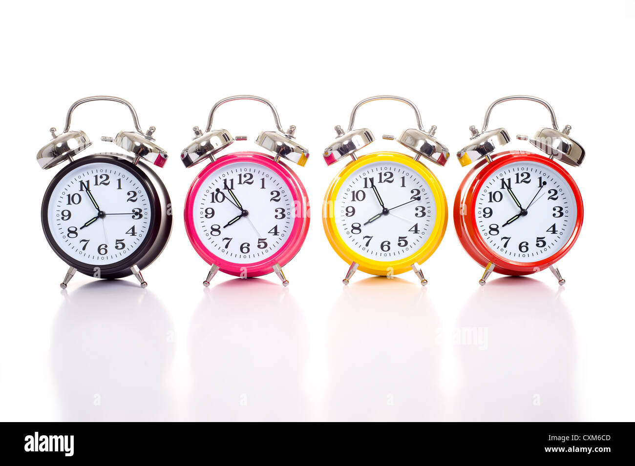 a group of multicolor clocks on a white background with copy space ...