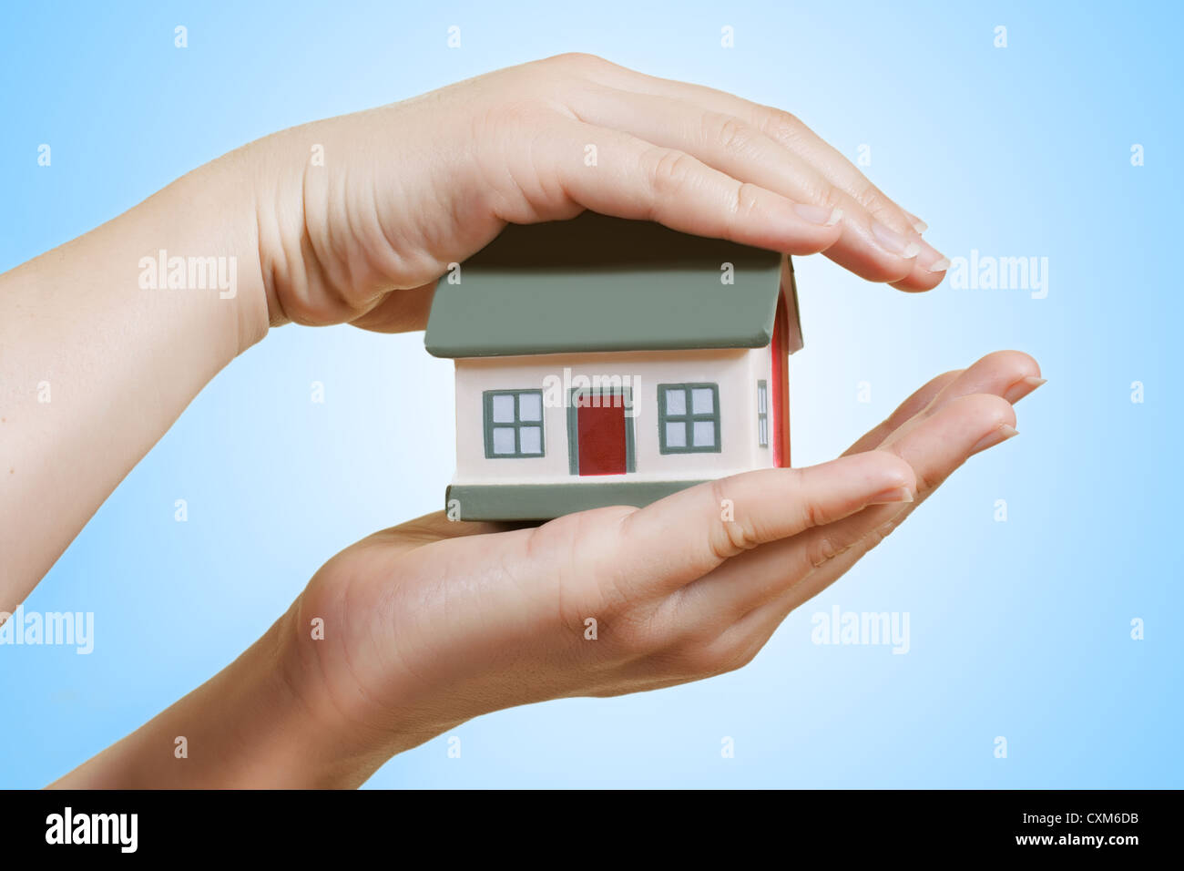 Home in human hands Stock Photo - Alamy