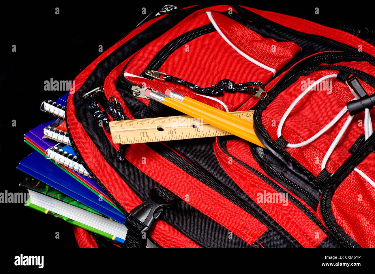 A red school backpack full of school supplies Stock Photo - Alamy